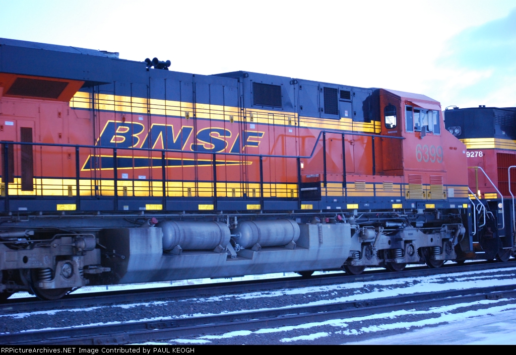 BNSF 6399 close up shot as she rolls east past me reflecting her Swoosh logo.